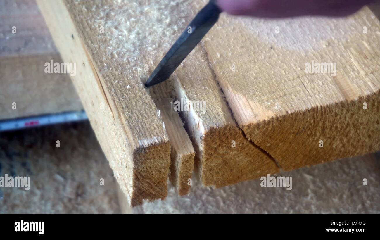 a worker uses a chisel to work with wood Board Stock Photo - Alamy
