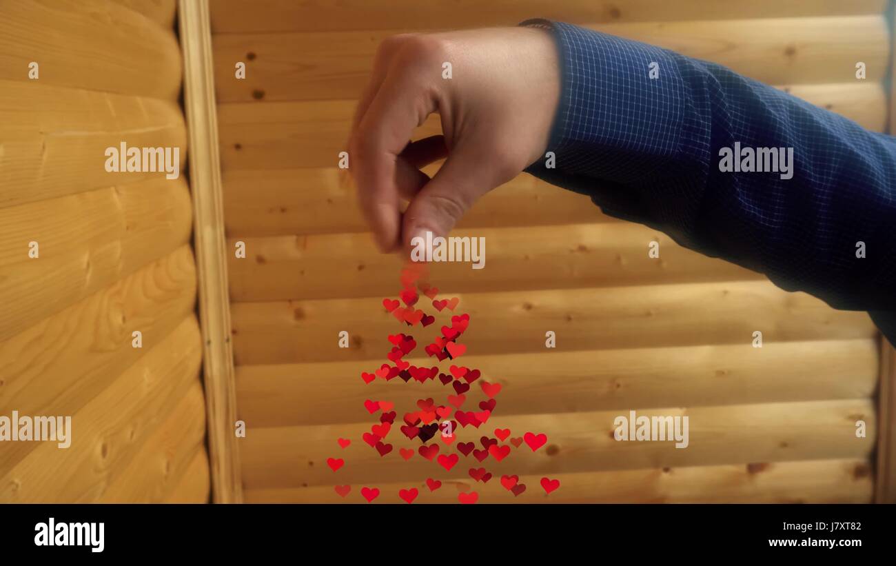 from the hand of a young man pouring a bunch of hearts Stock Photo - Alamy