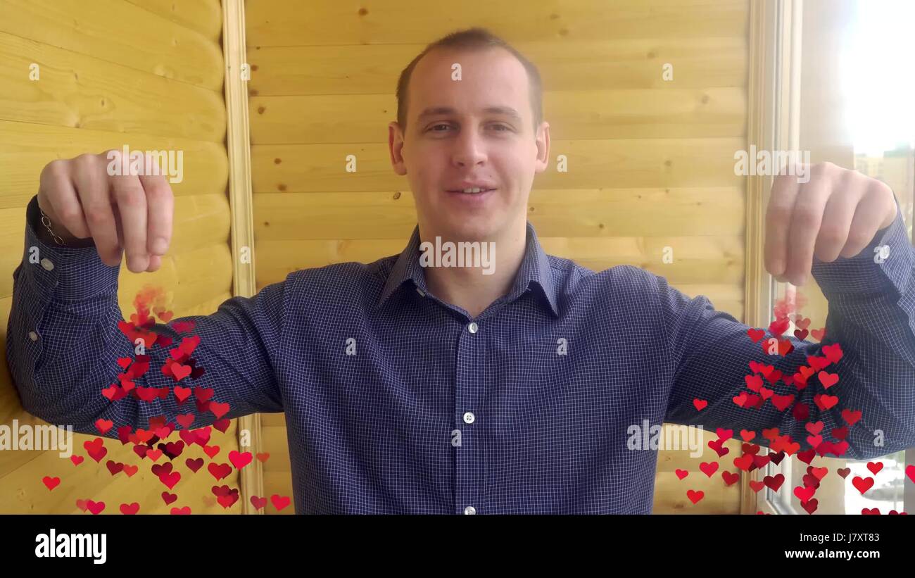 from the hand of a young man pouring a bunch of hearts Stock Photo - Alamy