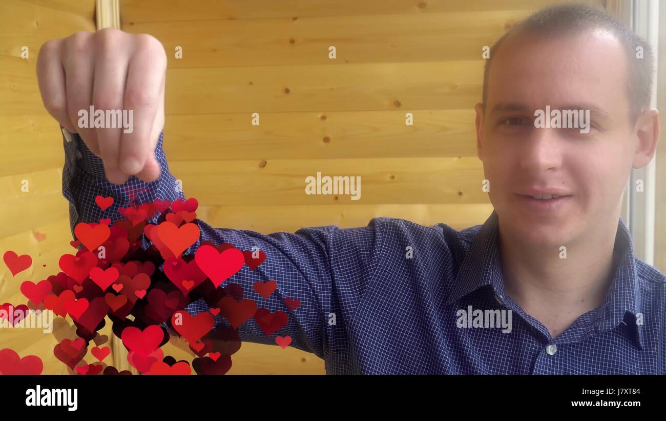 from the hand of a young man pouring a bunch of hearts Stock Photo - Alamy