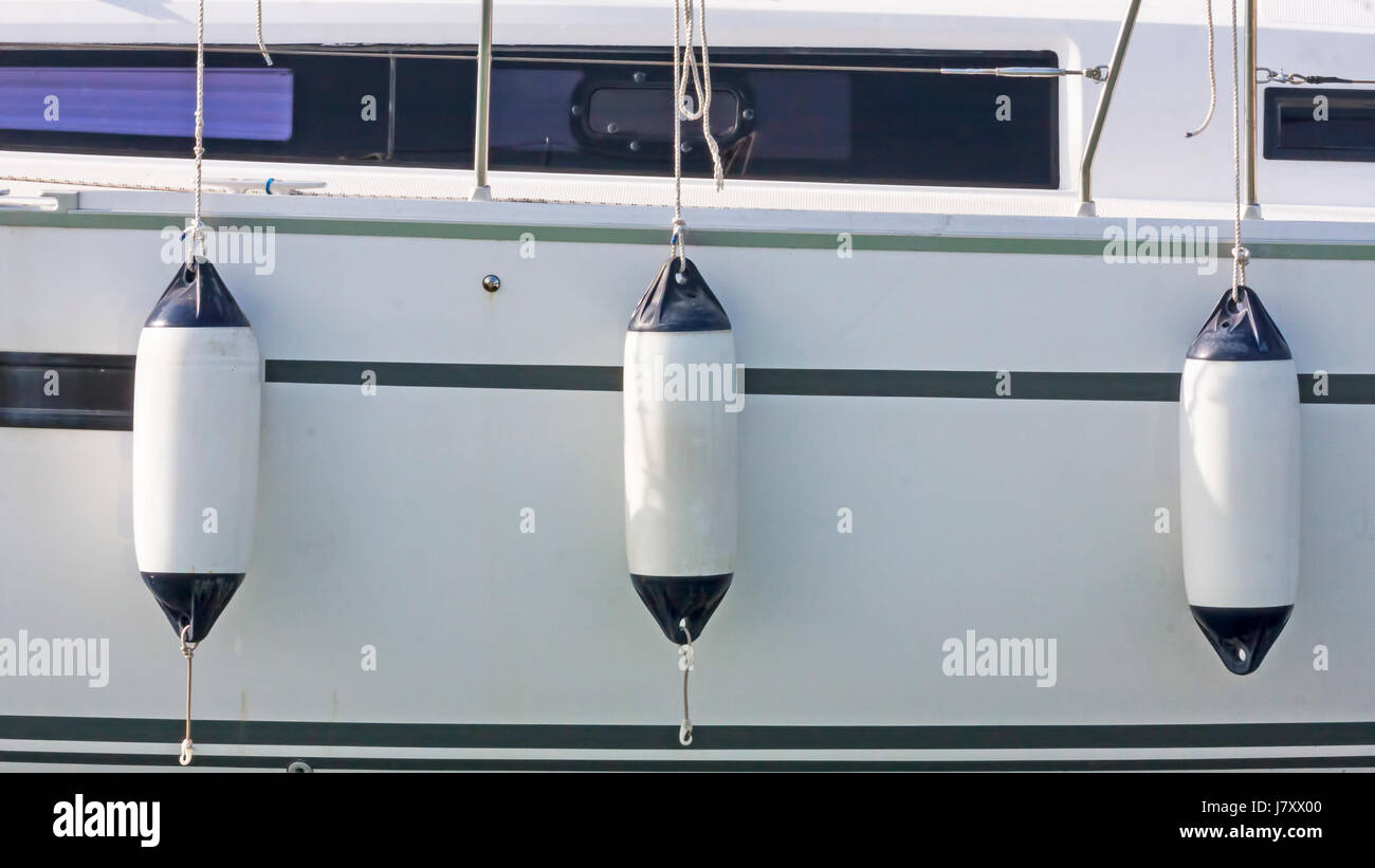 Sailboat side with fenders Stock Photo - Alamy
