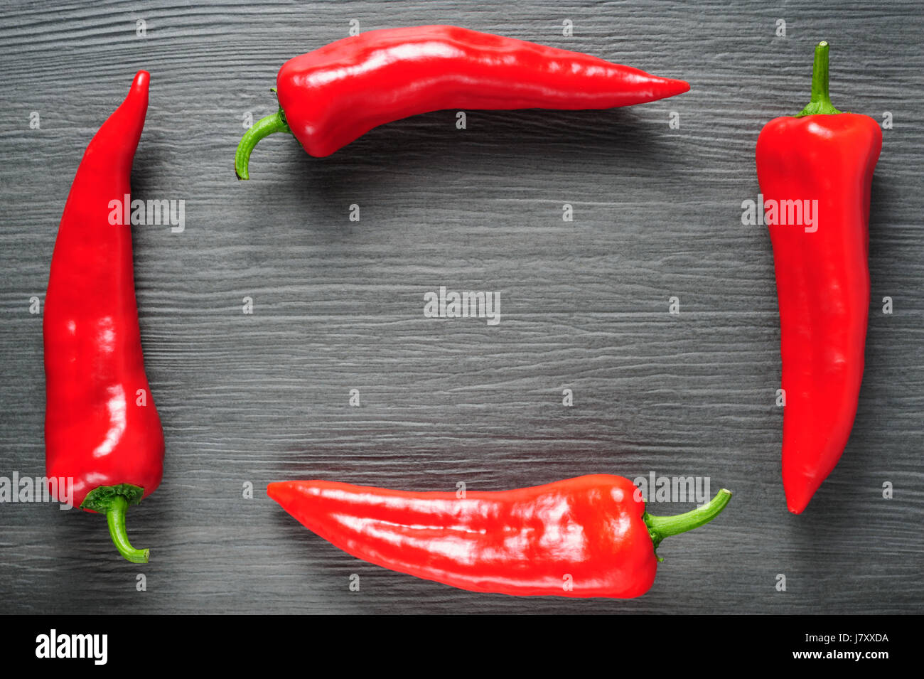 Frame made of sweet red Kapia peppers on a dark shale Stock Photo - Alamy