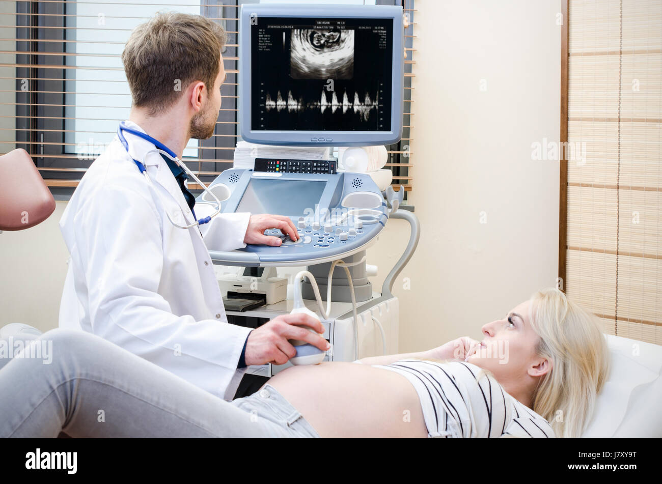 Pregnant woman at the doctor. Ultrasound diagnostic machine. ultrasound ...