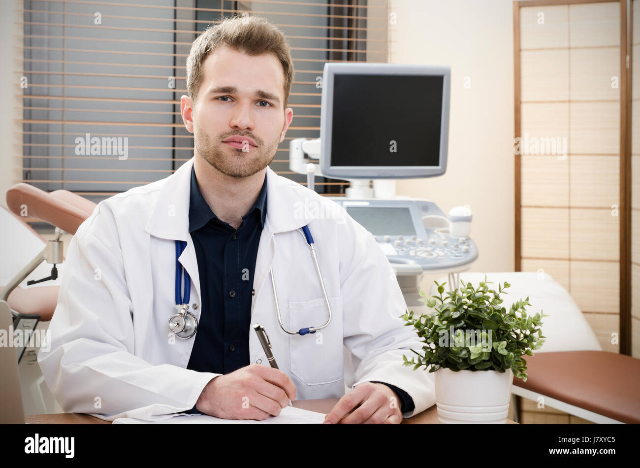 Doctor gynecologist working in office. Ultrasound in background. doctor ...