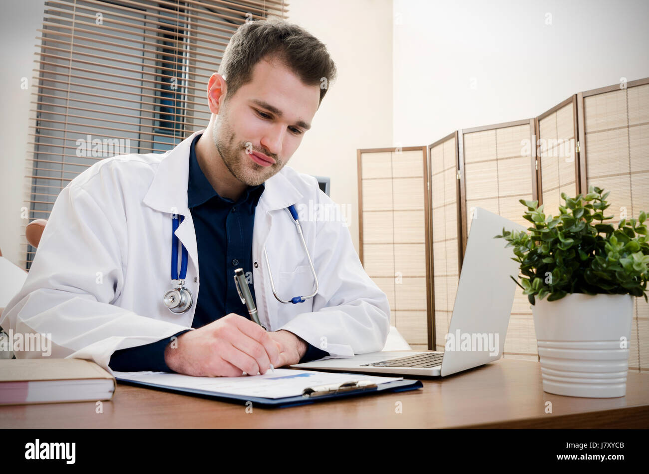 Doctor gynecologist working in office. Ultrasound in background. doctor ...