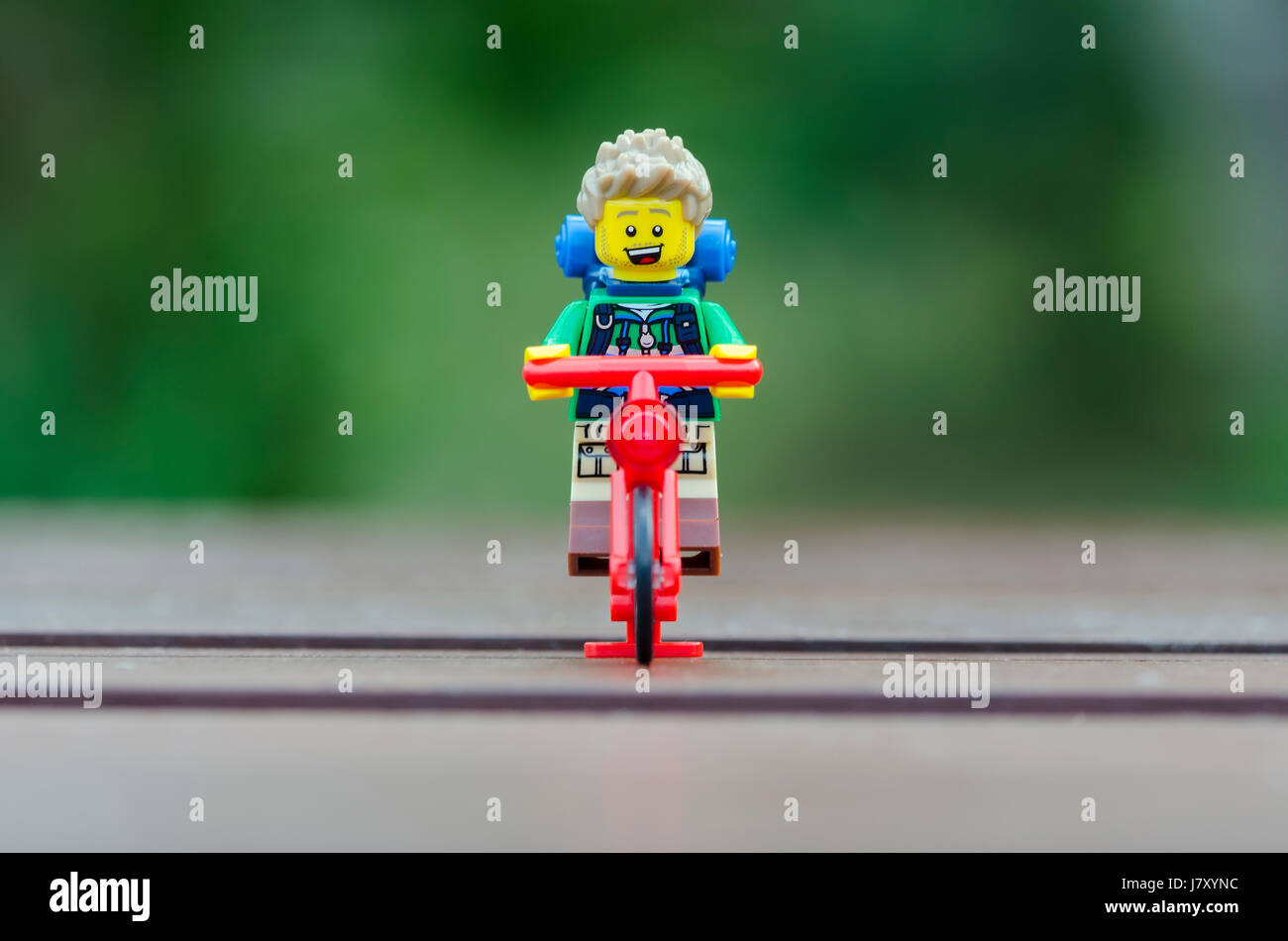 Lego hiker riding bicycle Stock Photo - Alamy