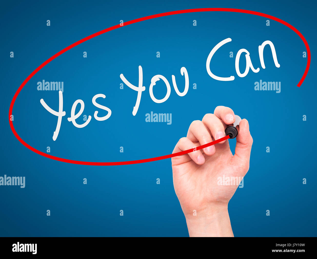 Man Hand writing Yes You Can with marker on transparent wipe board ...