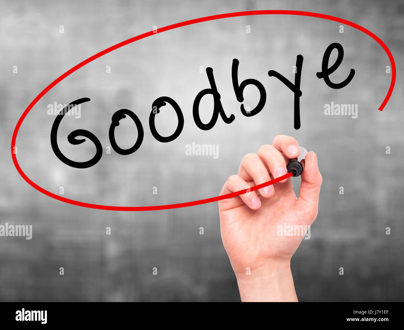 Man Hand writing Goodbye with marker on transparent wipe board ...