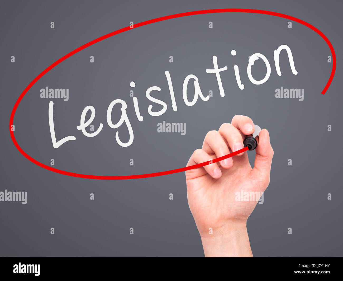 Man Hand writing Legislation with marker on transparent wipe board ...