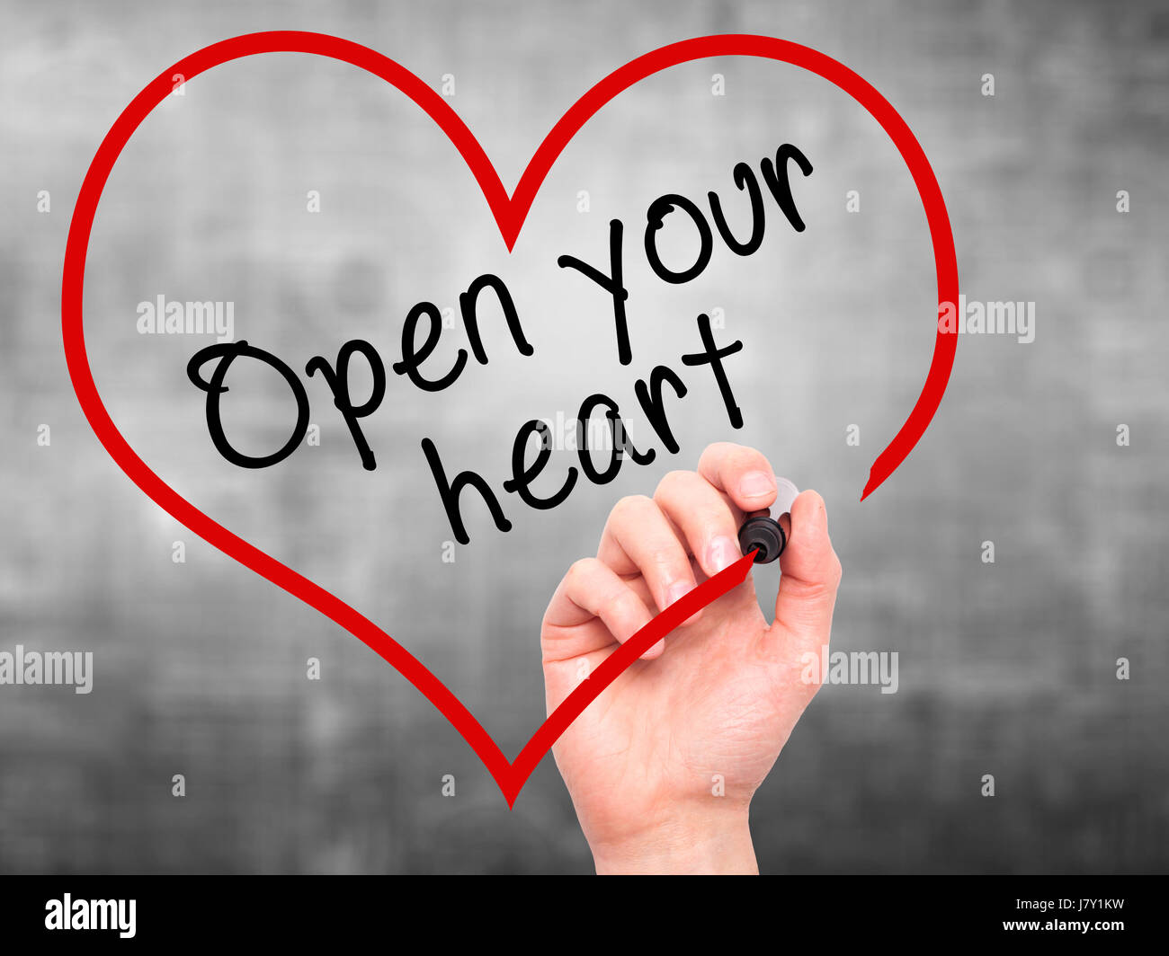 Man Hand writing Open your heart with marker on transparent wipe board ...