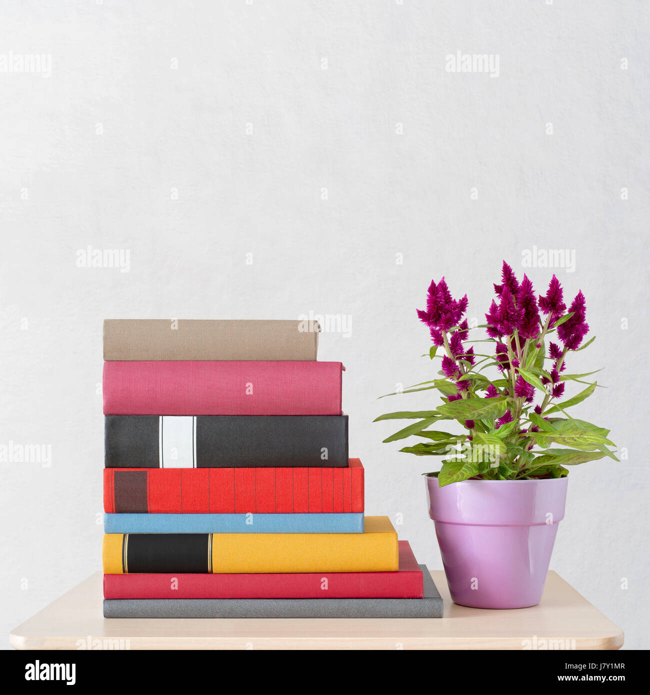 stack of books and flowers in the pot on the table Stock Photo - Alamy