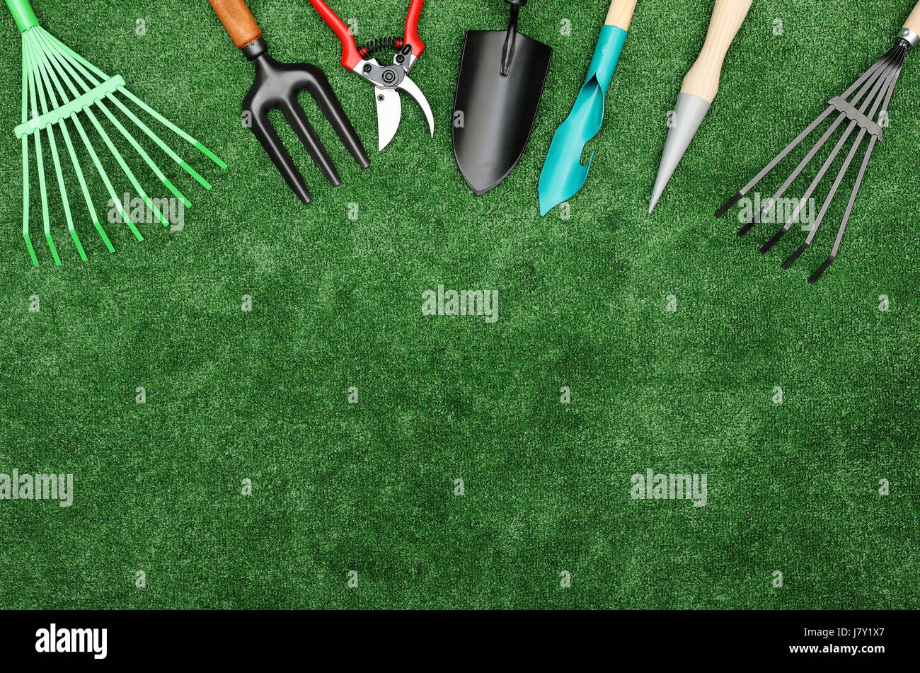 Gardening tools on grass background Stock Photo - Alamy