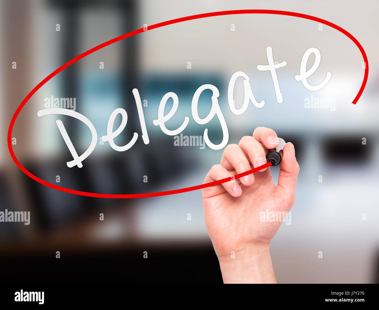 Man Hand writing Delegate black marker on visual screen. Isolated on ...