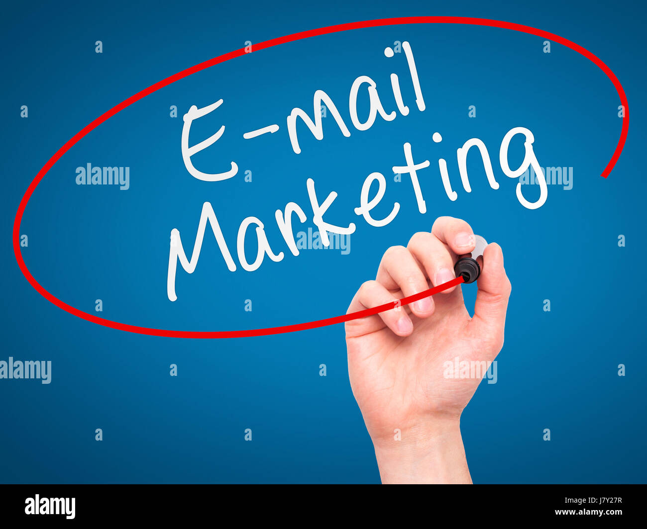 Man Hand writing E-mail Marketing with marker on transparent wipe board ...