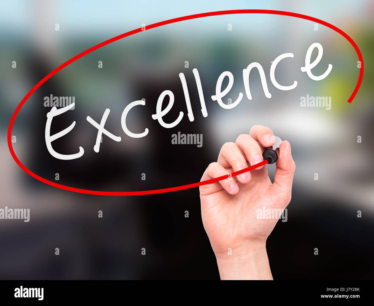 Man Hand writing Excellence with marker on transparent wipe board ...