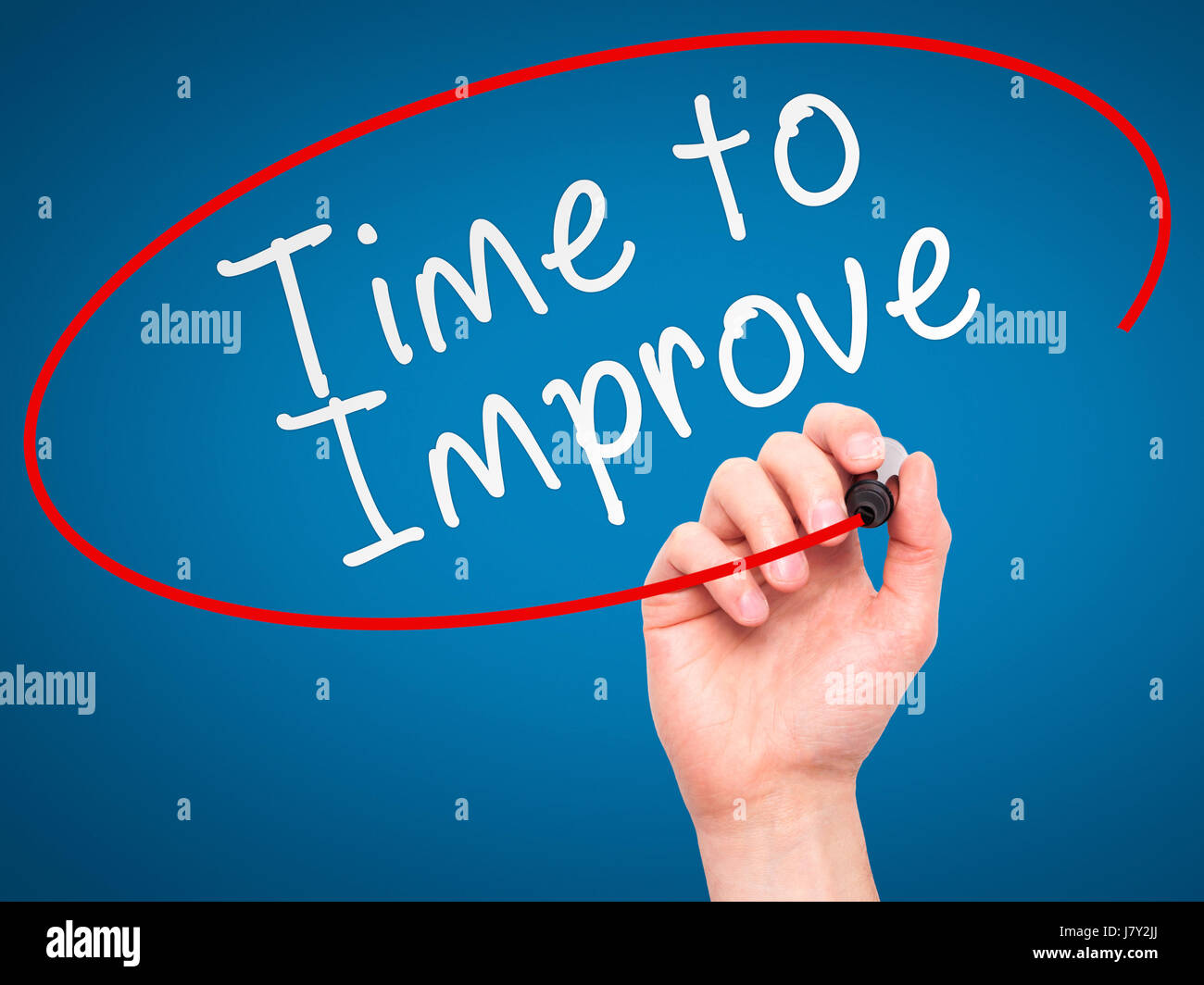 Man Hand writing Time to Improve with marker on transparent wipe board ...