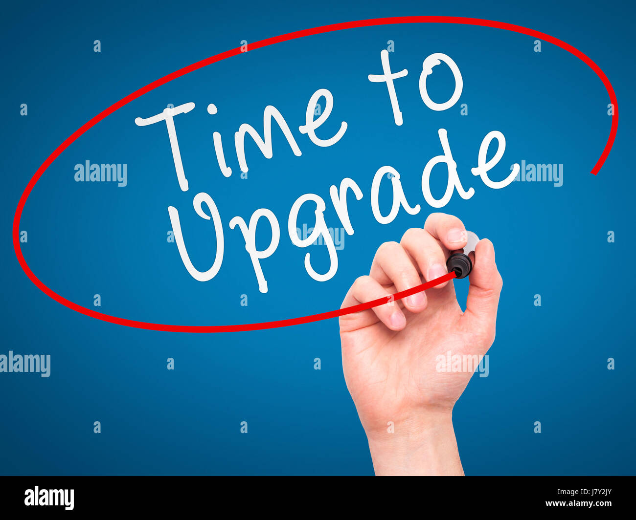 Man Hand writing Time to Upgrade with marker on transparent wipe board ...