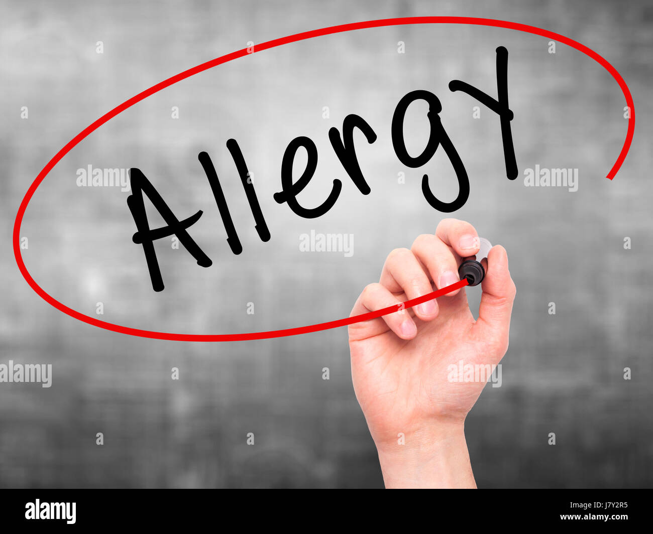 Man Hand writing Allergy with marker on transparent wipe board ...