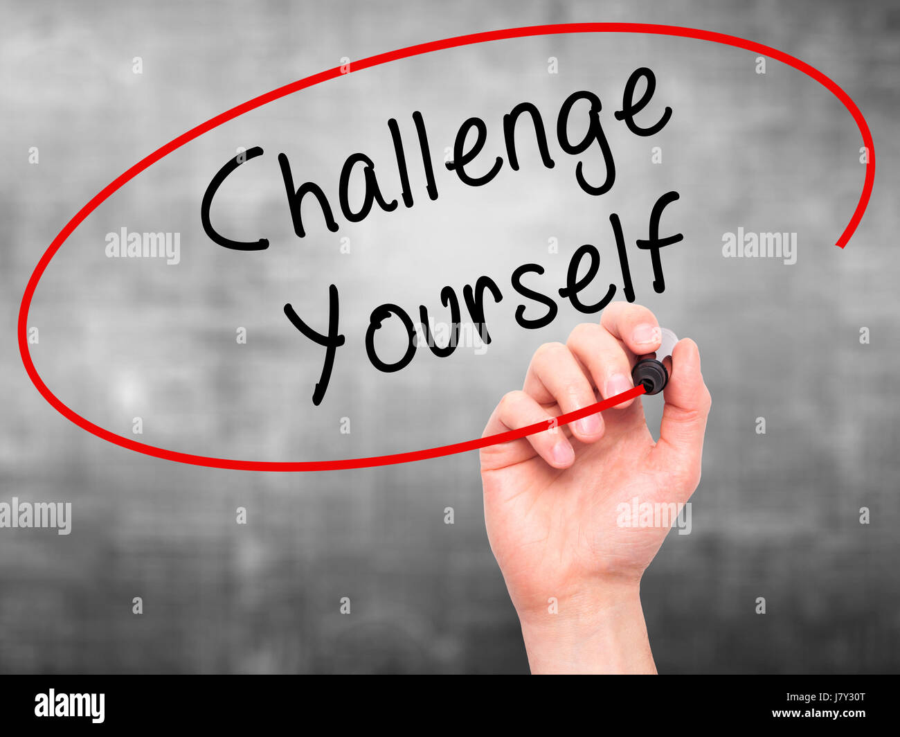 Man Hand writing Challenge Yourself with marker on transparent wipe ...