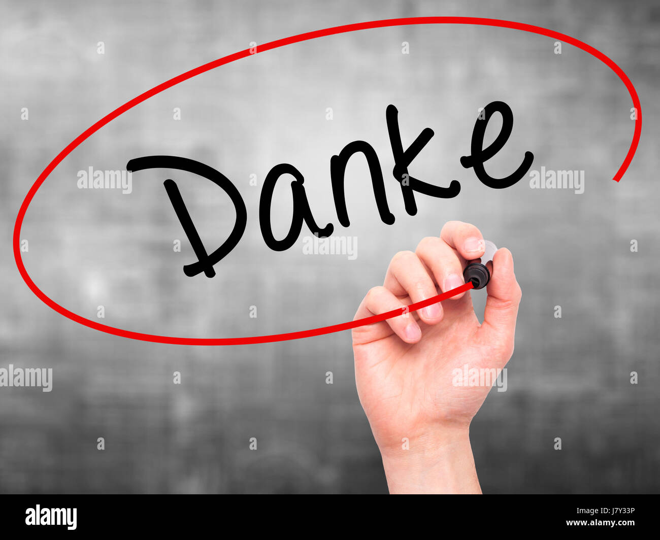 Man Hand writing Danke with marker on transparent wipe board. Isolated ...