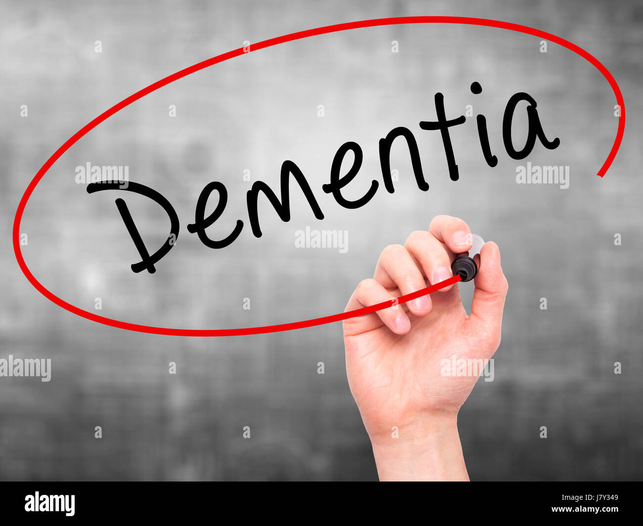 Man Hand writing Dementia with marker on transparent wipe board ...