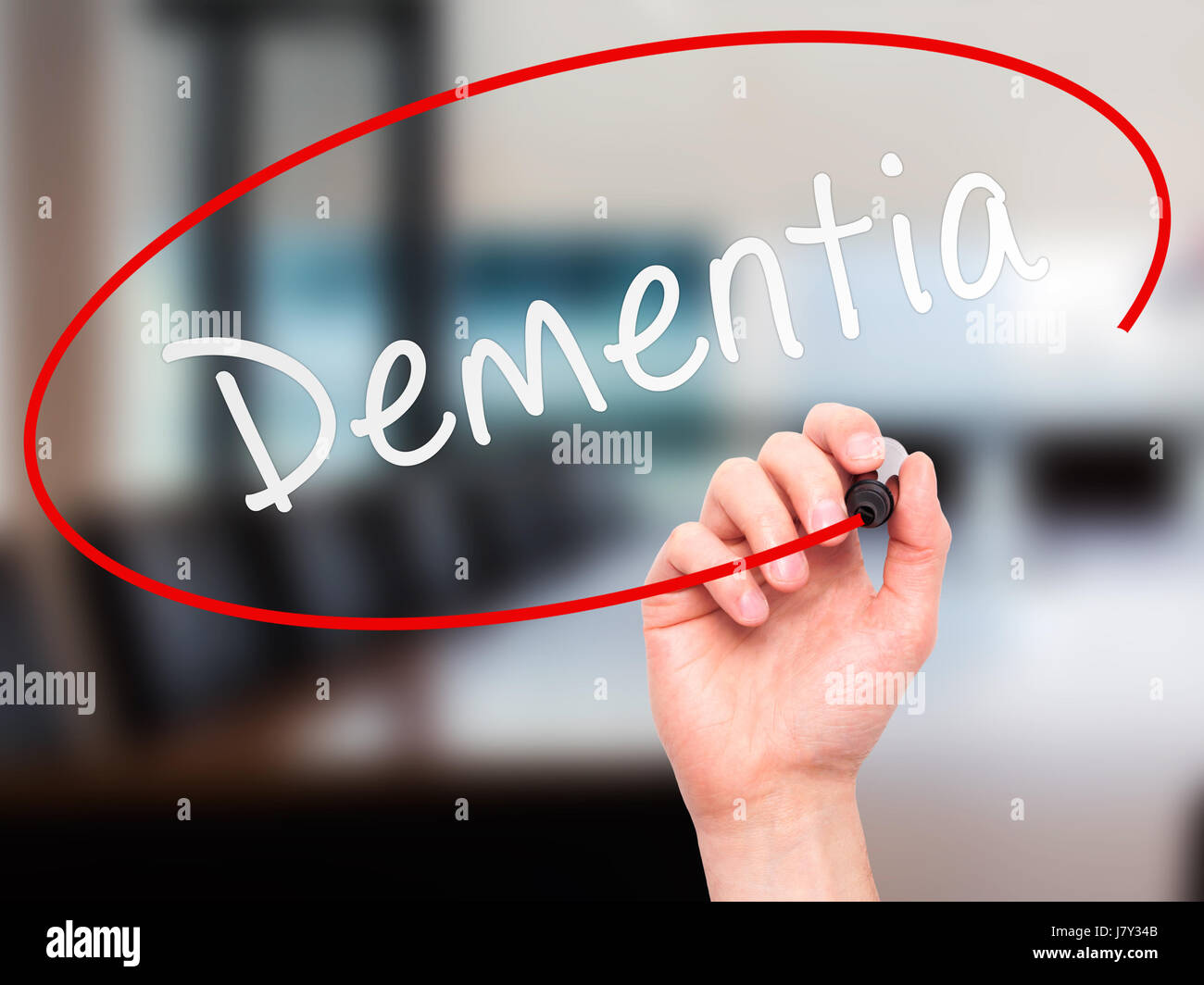 Man Hand writing Dementia with marker on transparent wipe board ...