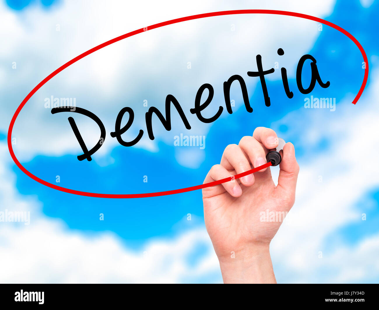 Man Hand writing Dementia with marker on transparent wipe board ...