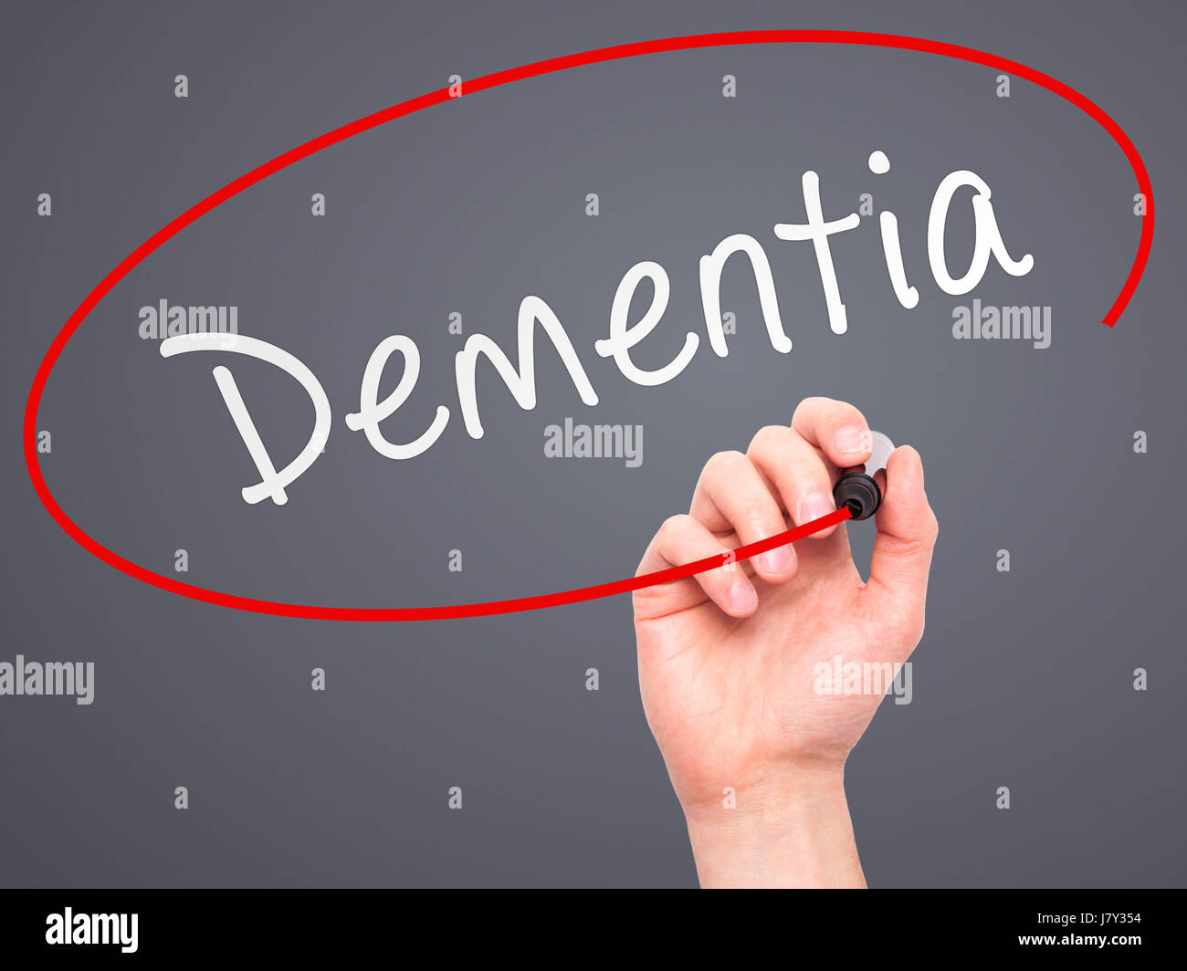 Man Hand writing Dementia with marker on transparent wipe board ...