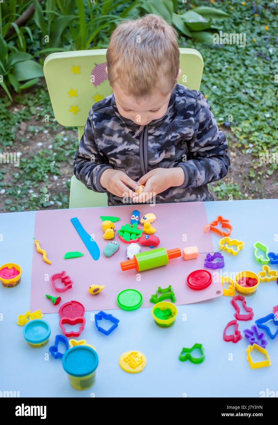 cute little boy playing with plasticine Stock Photo - Alamy