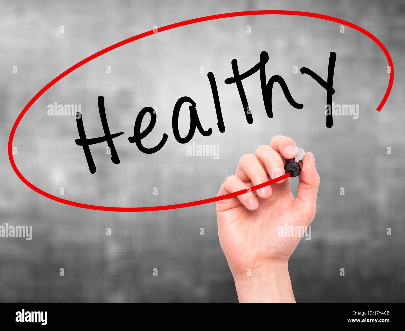 Man Hand writing Healthy with marker on transparent wipe board ...