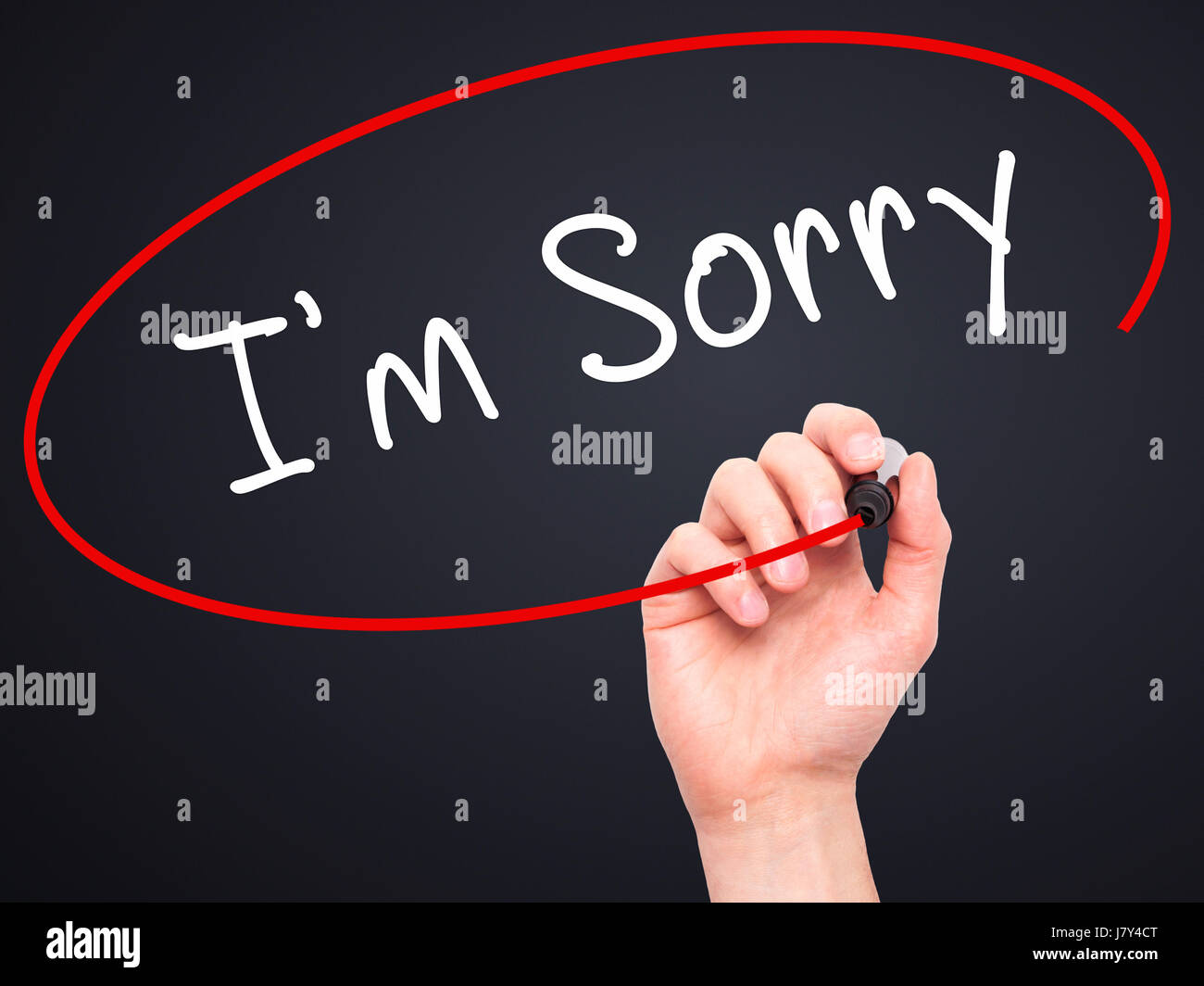 Man Hand writing I'm Sorry with marker on transparent wipe board ...