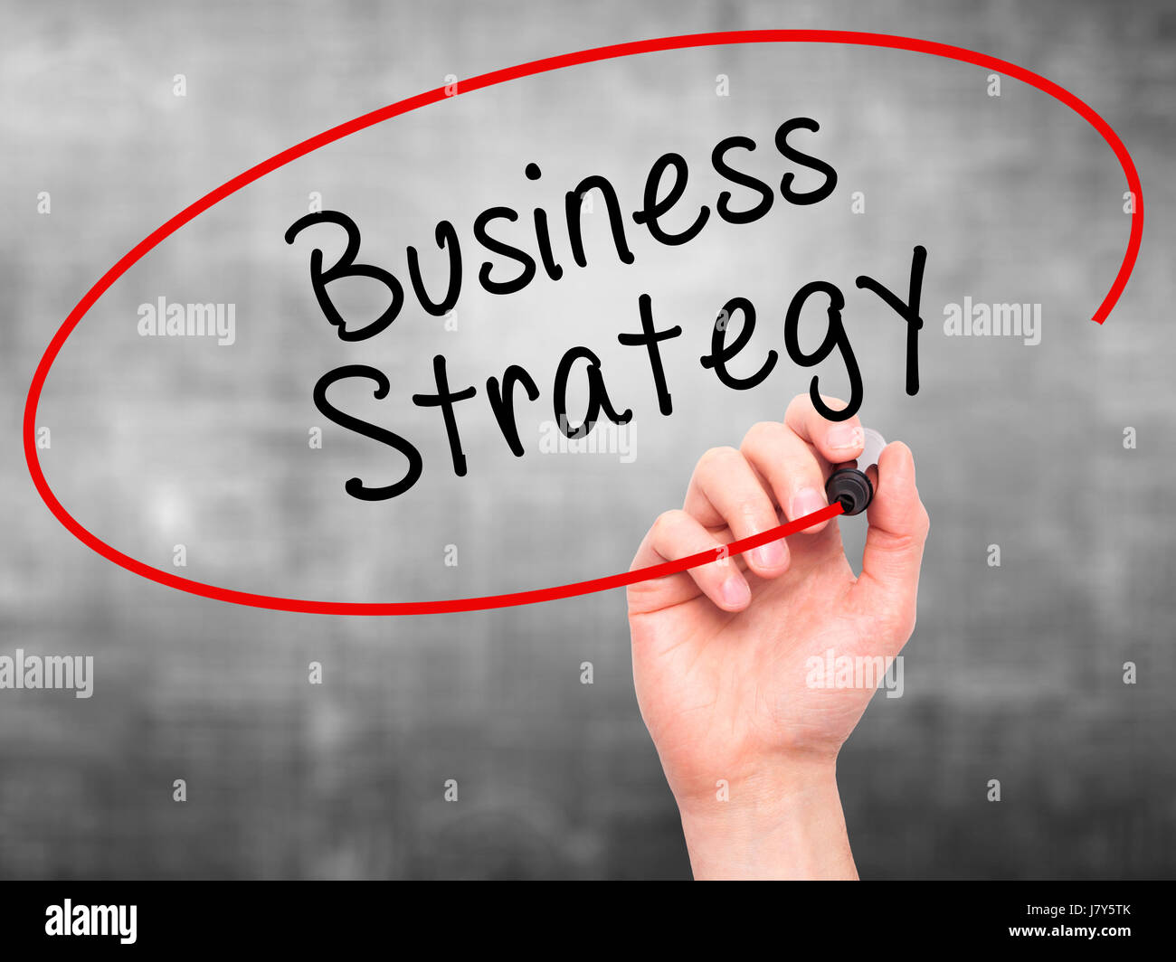 Man Hand writing Business Strategy with black marker on visual screen ...