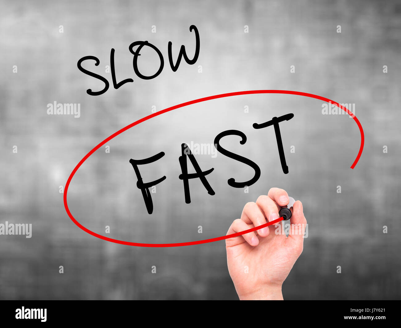 Man Hand writing and Choosing Fast instead of Slow with black marker on ...