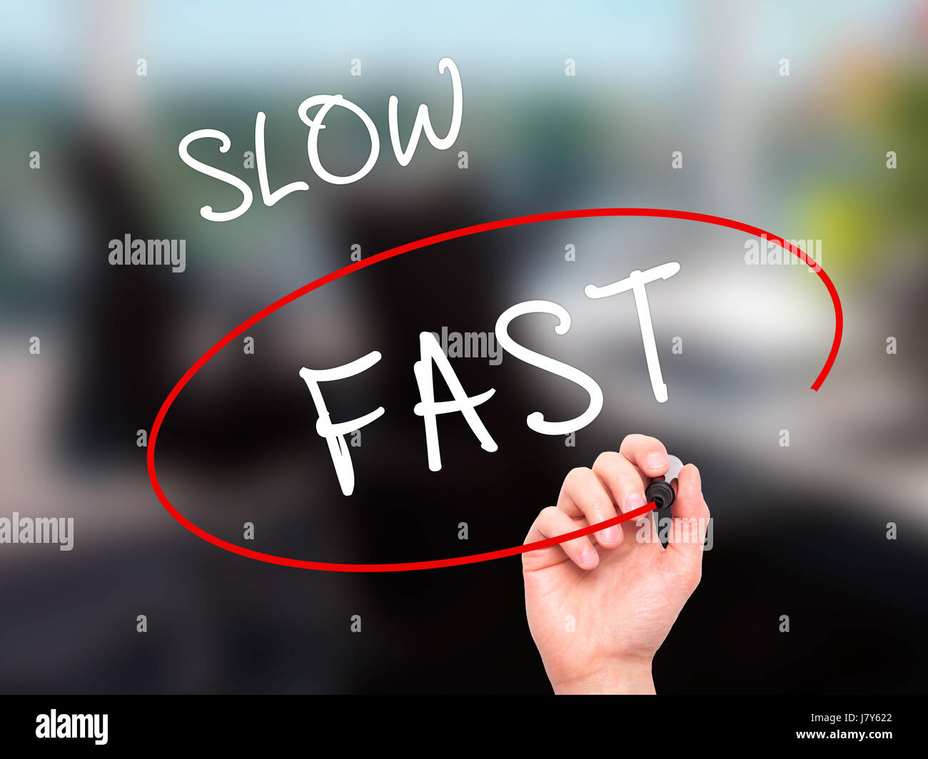 Man Hand writing and Choosing Fast instead of Slow with black marker on ...