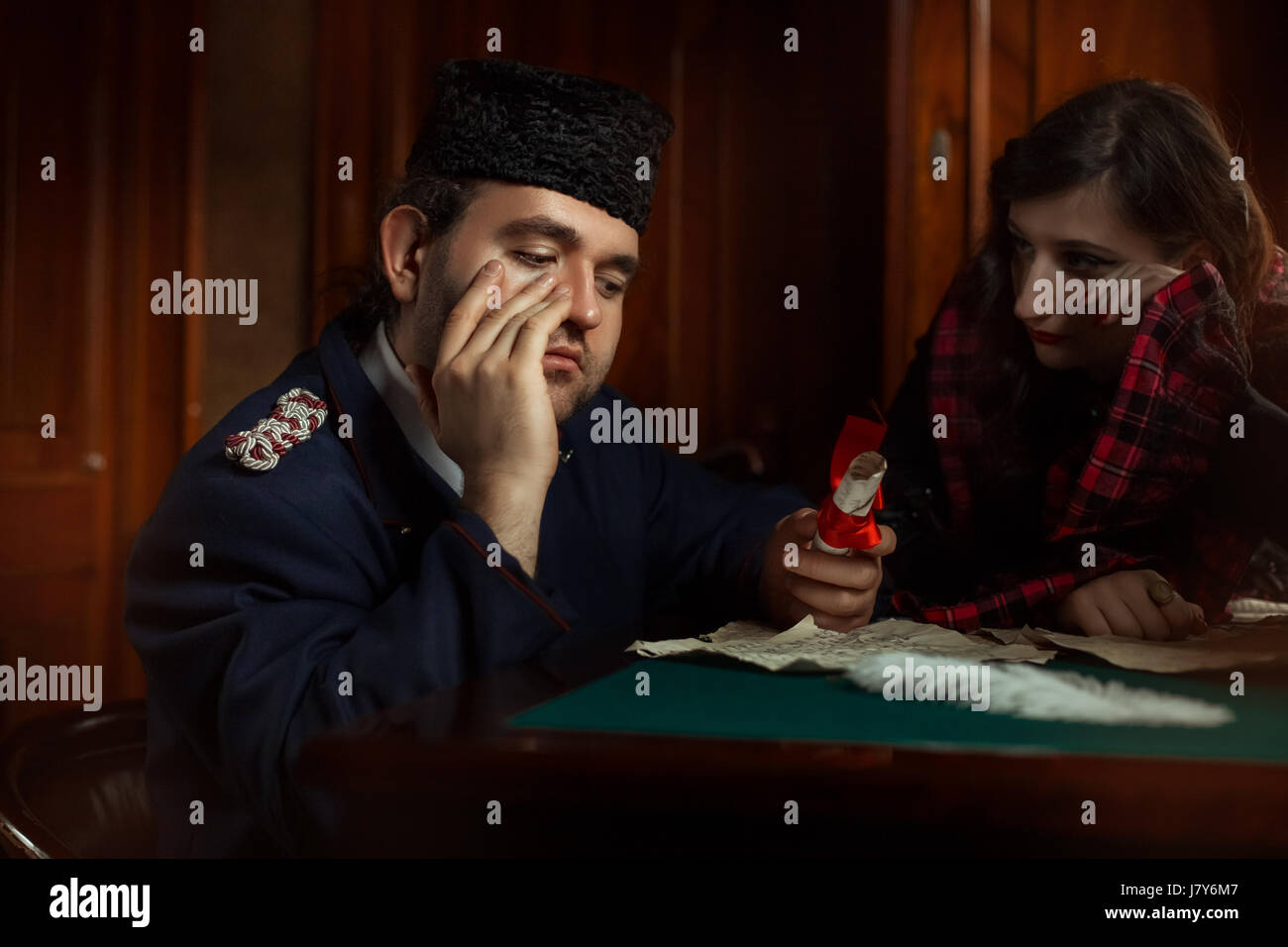 Man and woman in retro style weep over the manuscripts. The main ...