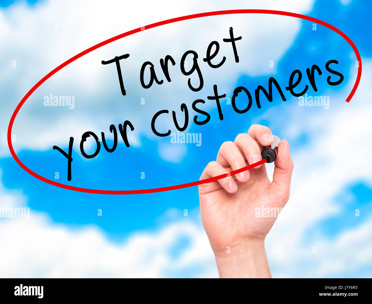 Man Hand writing Target your customers with black marker on visual ...
