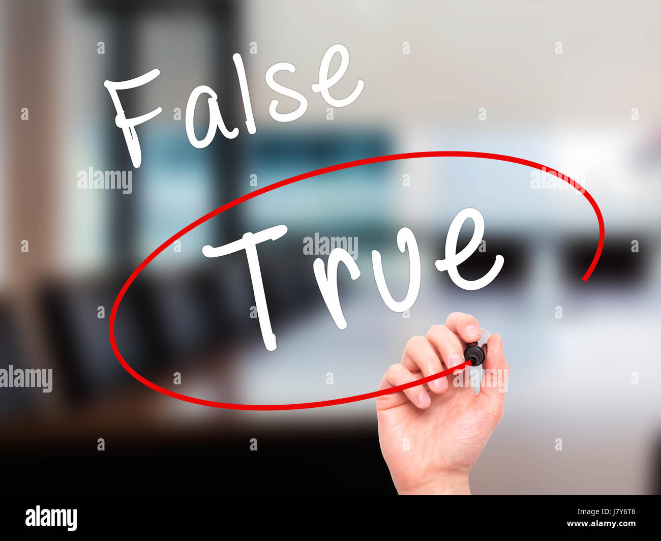 Man Hand writing an choosing True instead of False with black marker on ...
