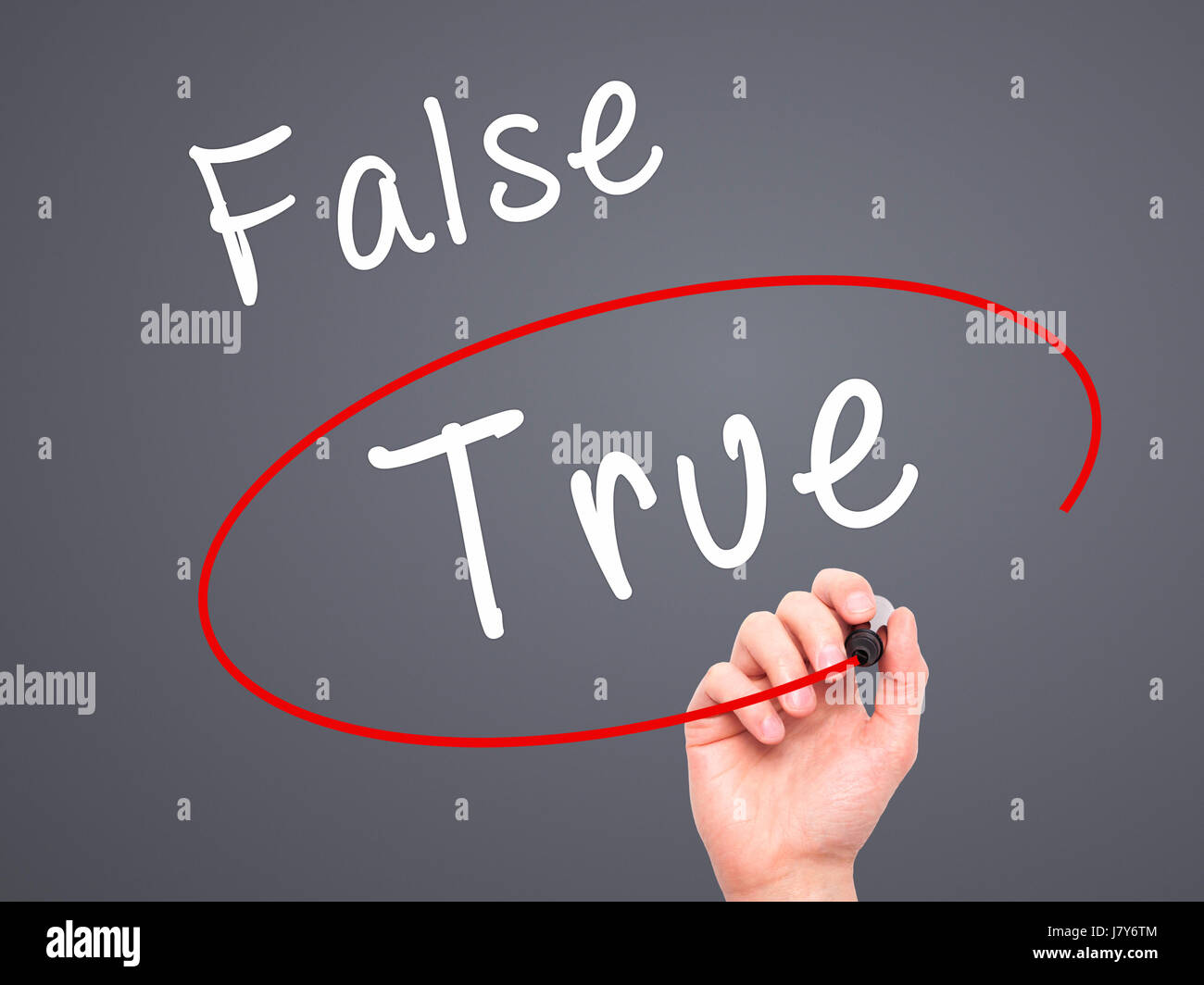 Man Hand writing an choosing True instead of False with black marker on ...