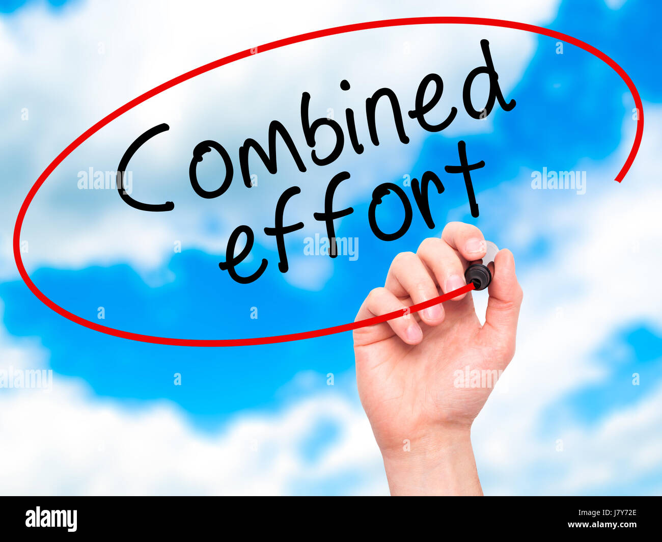 Man Hand writing Combined effort with black marker on visual screen ...