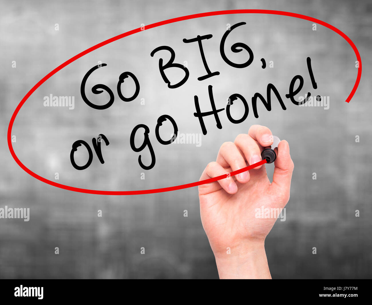 Man Hand writing Go Big or Go Home with black marker on visual screen ...