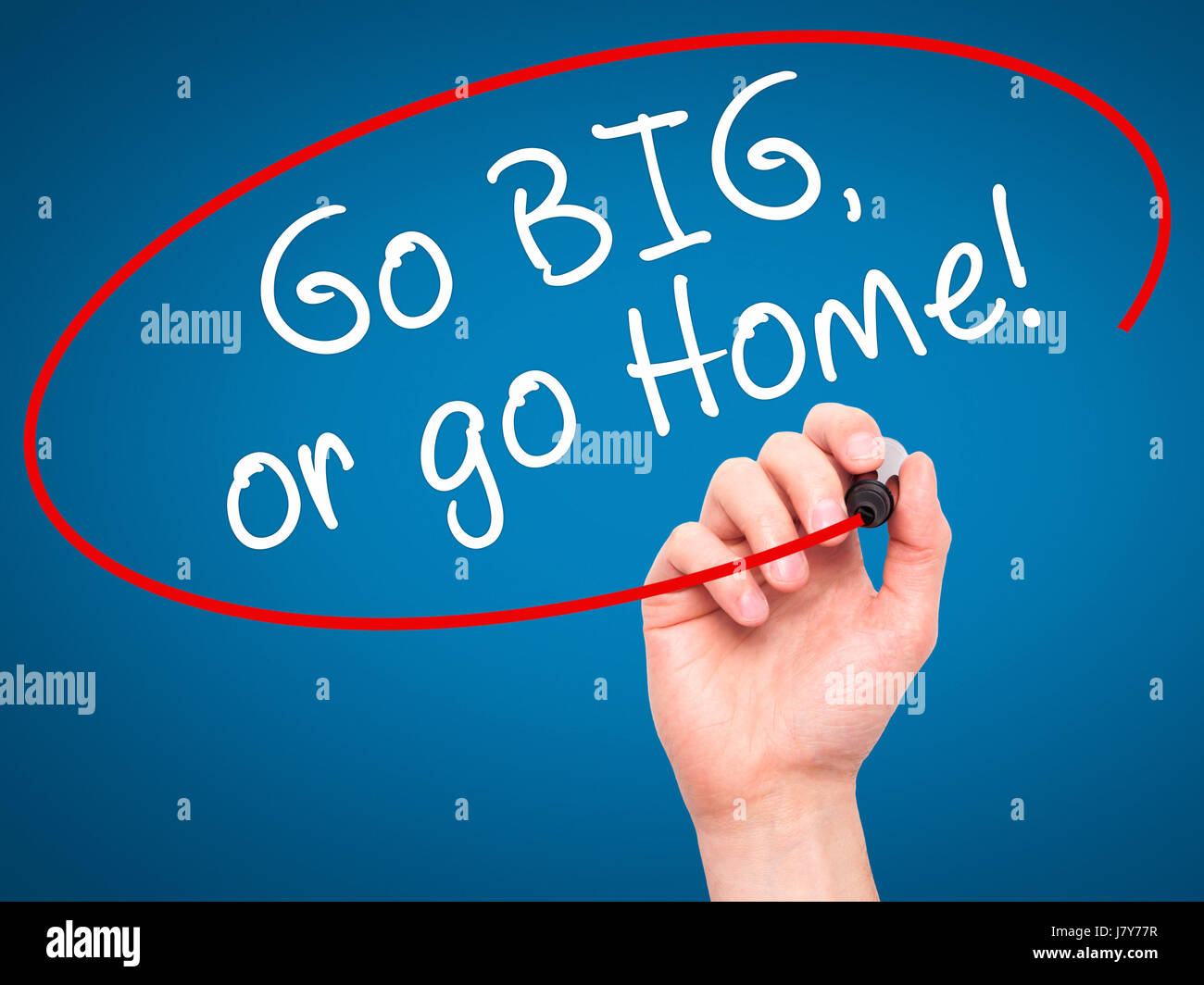 Man Hand writing Go Big or Go Home with black marker on visual screen ...