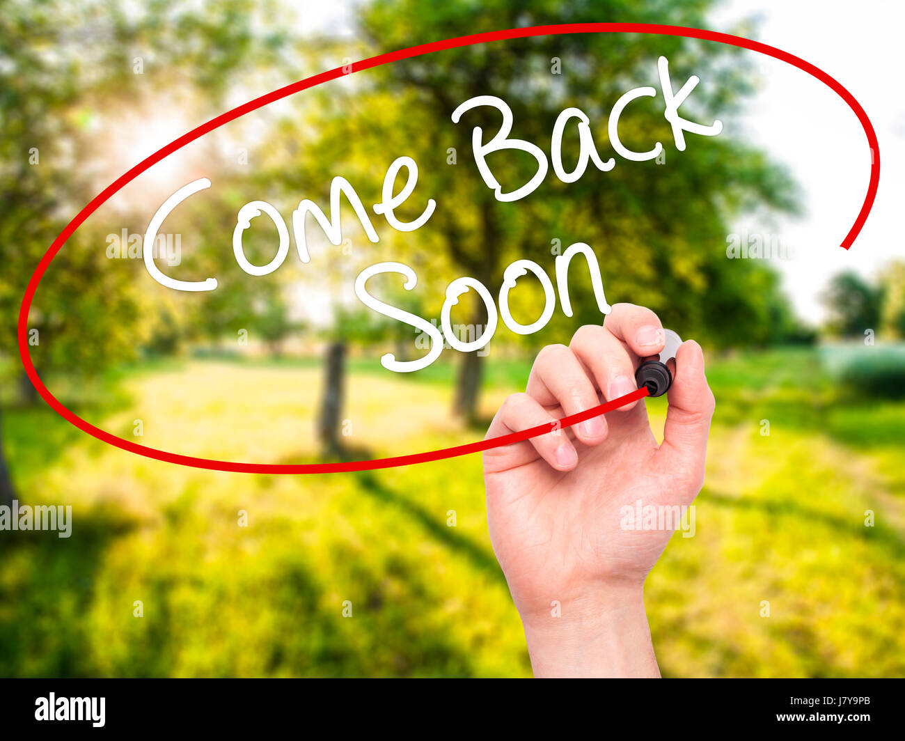 Man Hand writing Come Back Soon with black marker on visual screen ...