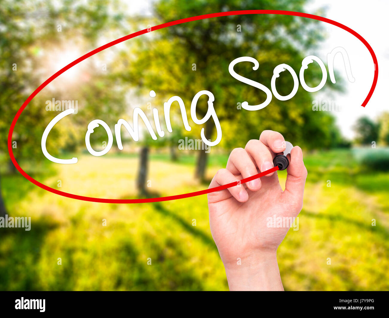 Man Hand writing Coming Soon with black marker on visual screen ...