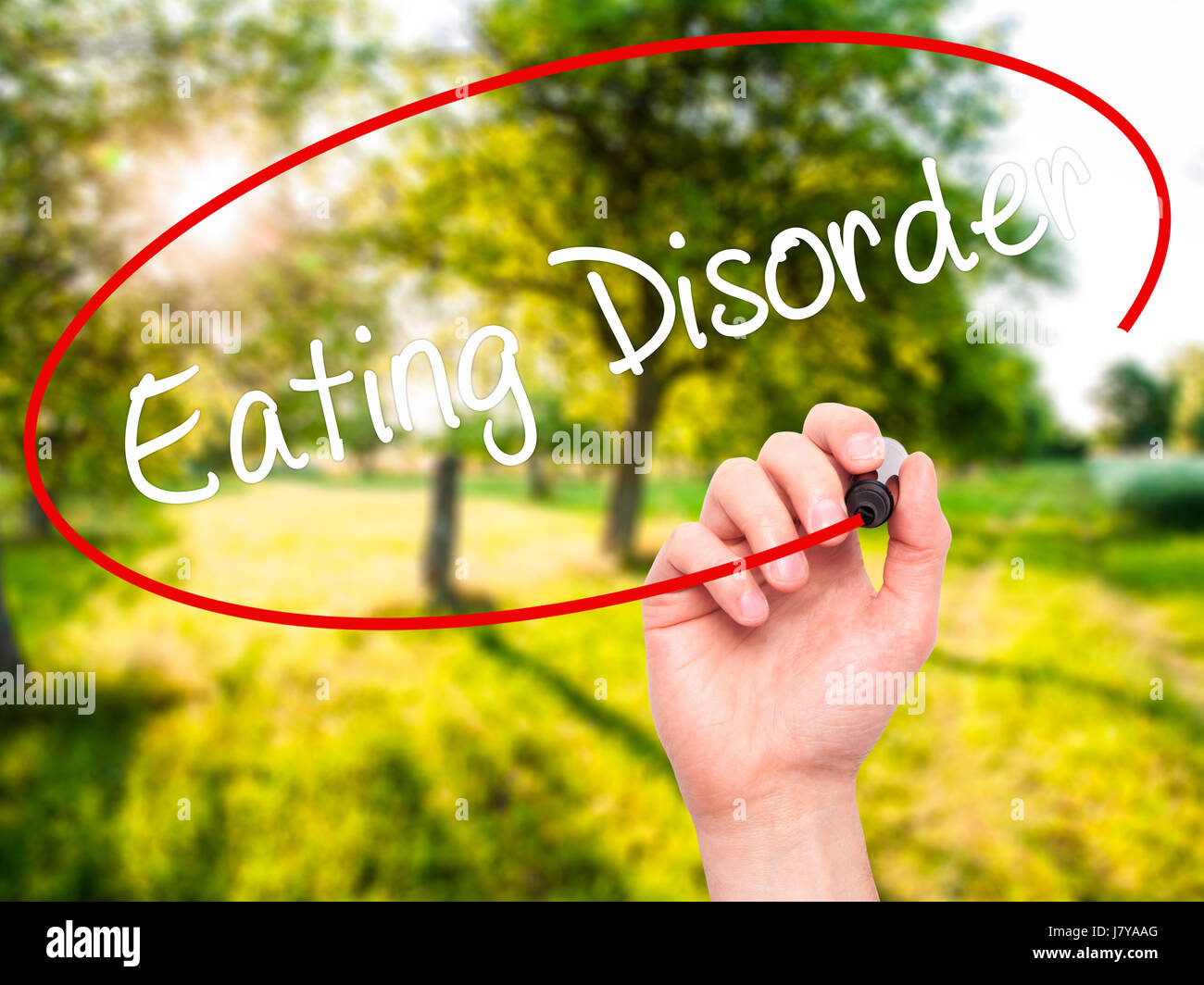 Man Hand writing Eating Disorder with black marker on visual screen ...