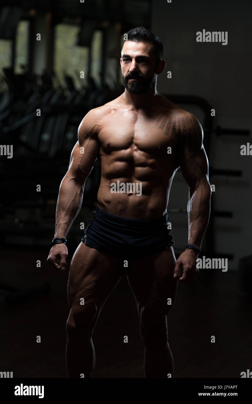 Portrait Of A Young Physically Fit Tattoo Man Showing His Well Trained ...