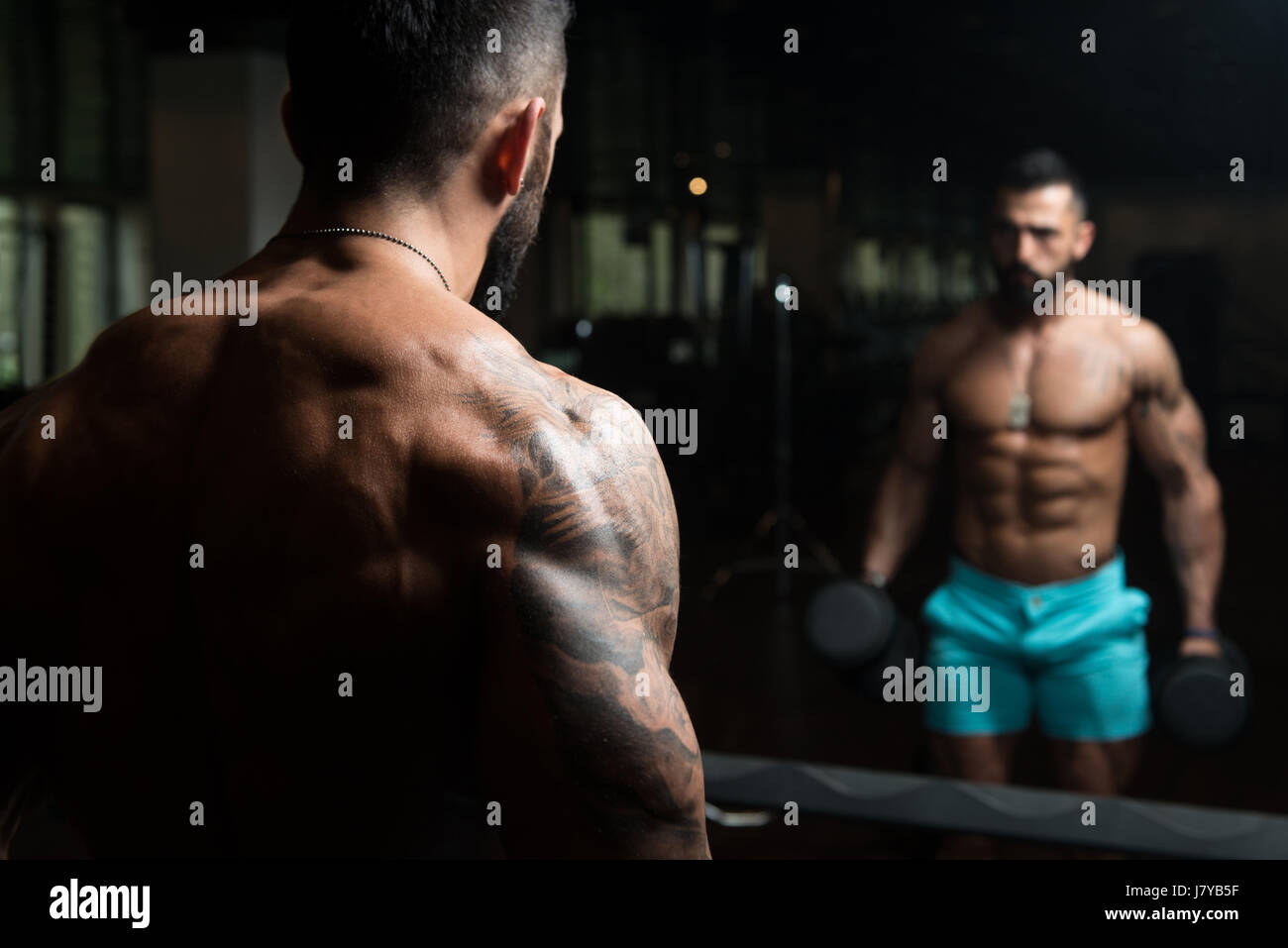 Man Working Out Biceps In A Gym - Dumbbell Concentration Curls Stock ...