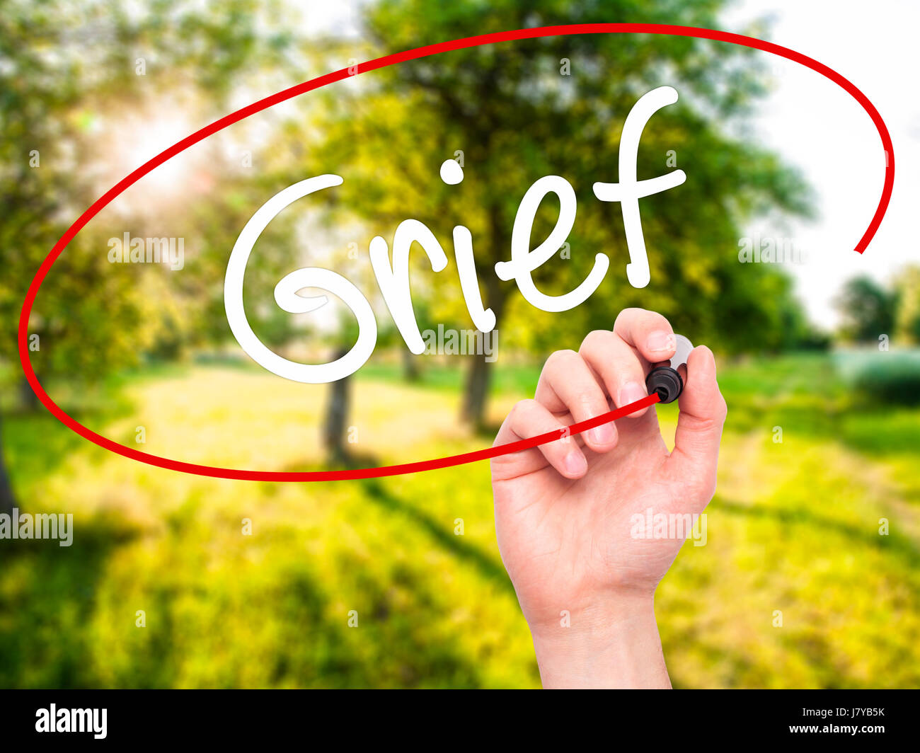 Man Hand writing Grief with black marker on visual screen. Isolated on ...