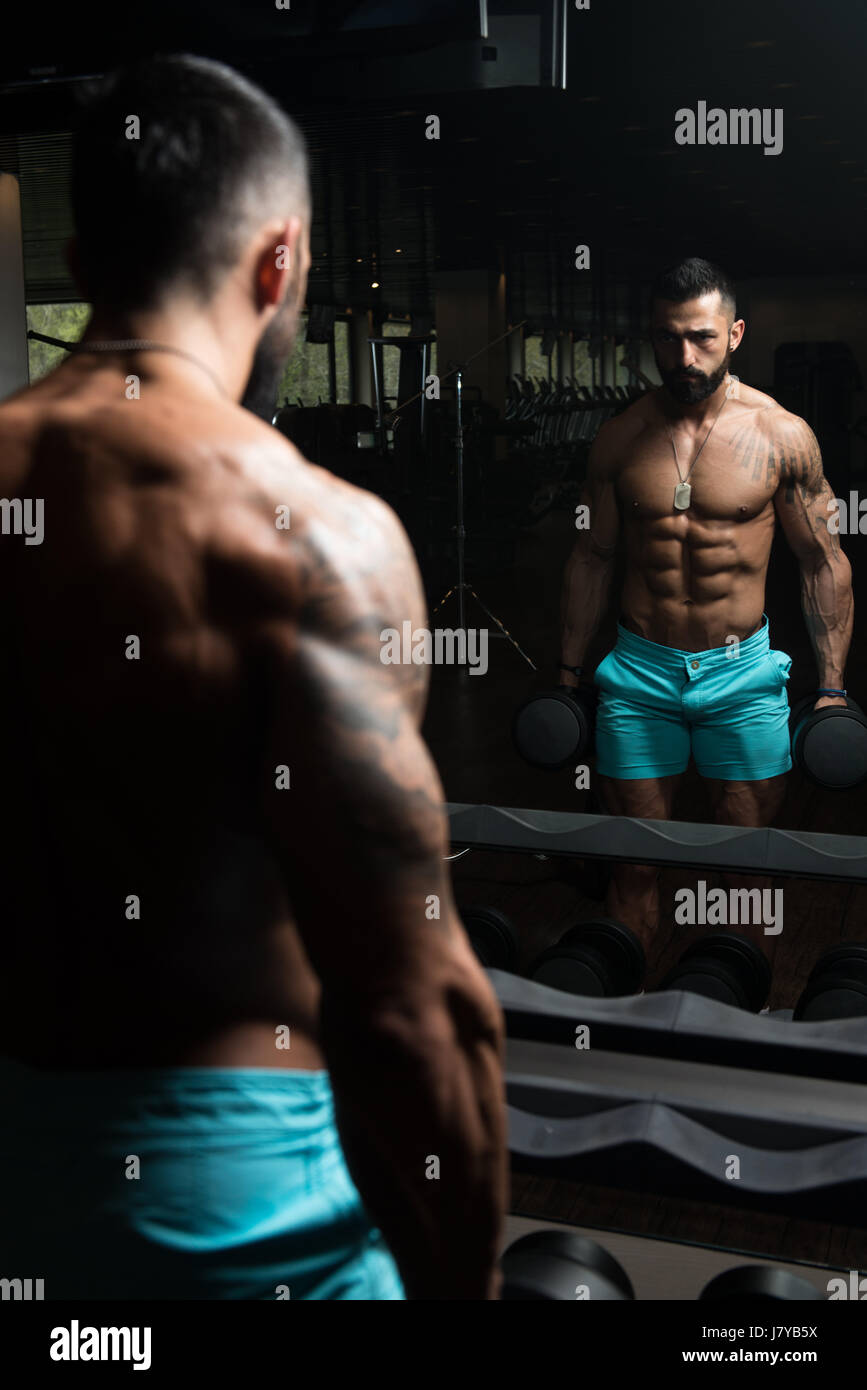 Man Working Out Biceps In A Gym - Dumbbell Concentration Curls Stock ...