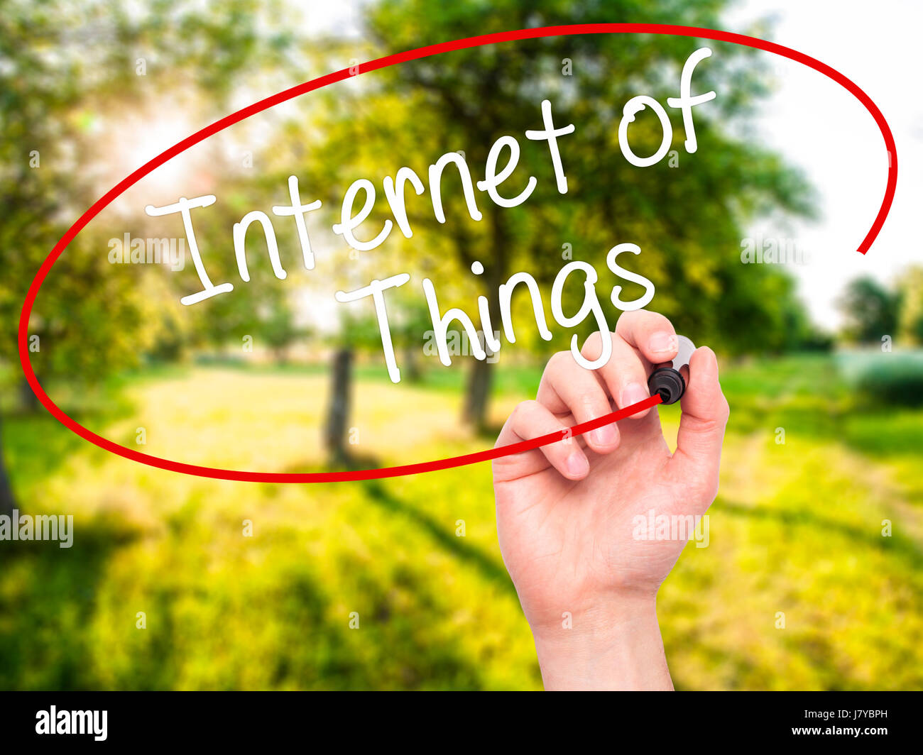 Man Hand writing Internet of Things with black marker on visual screen ...