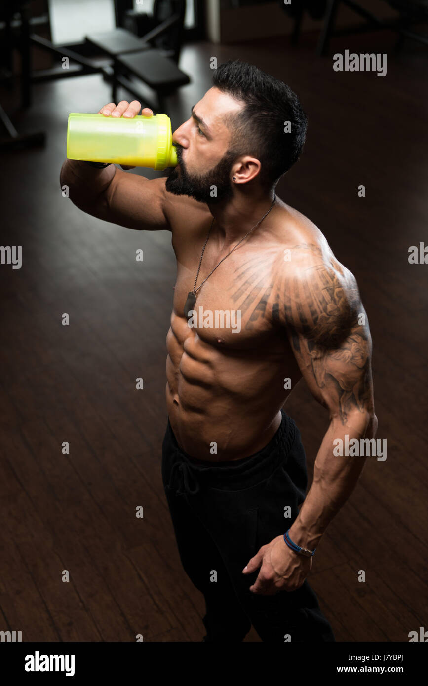 Muscular Man Resting After Exercise And Drinking From Shaker Stock ...